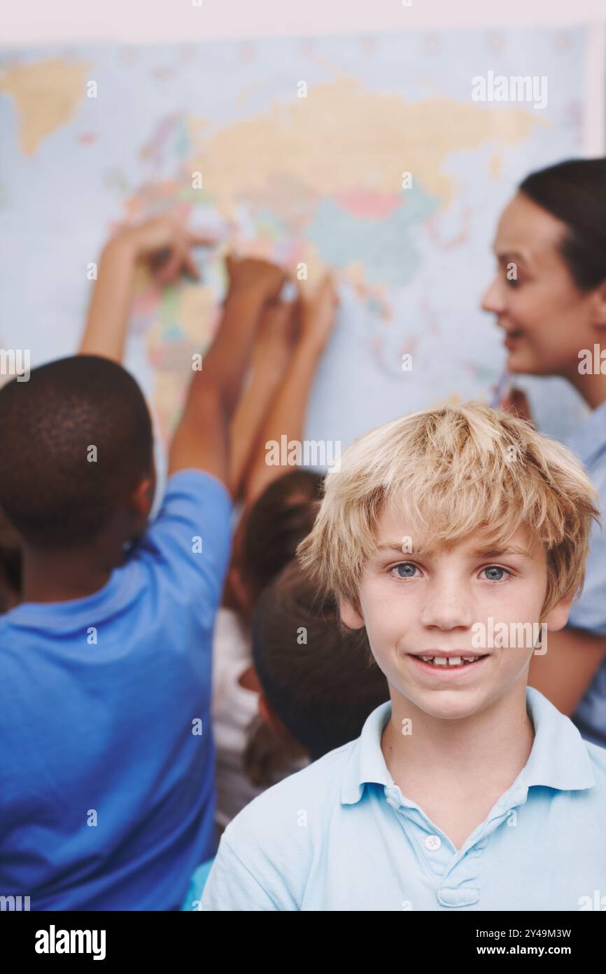 World map, learning and portrait of child in classroom for direction ...