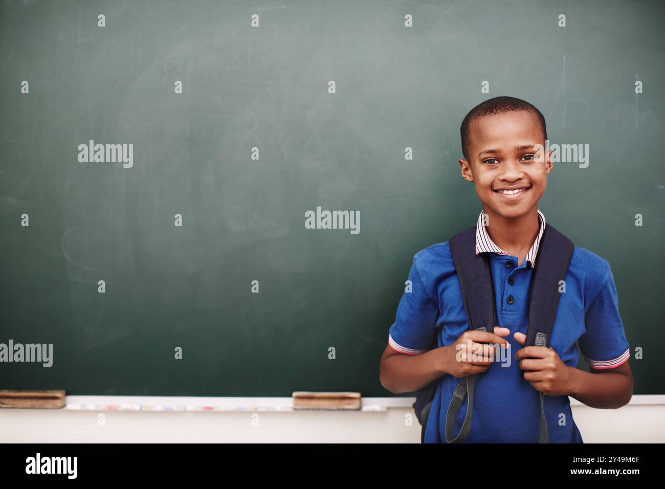 Education, portrait and smile of student on chalkboard in school ...