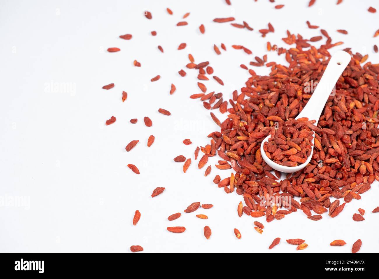 Dried Goji berries Lycium barbarum in a spoon on a white background ...