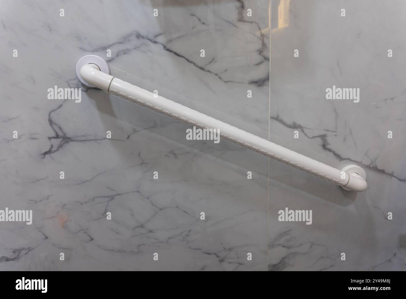 Focus on hand rail fixture on wall inside wc toilet to aid users with ...