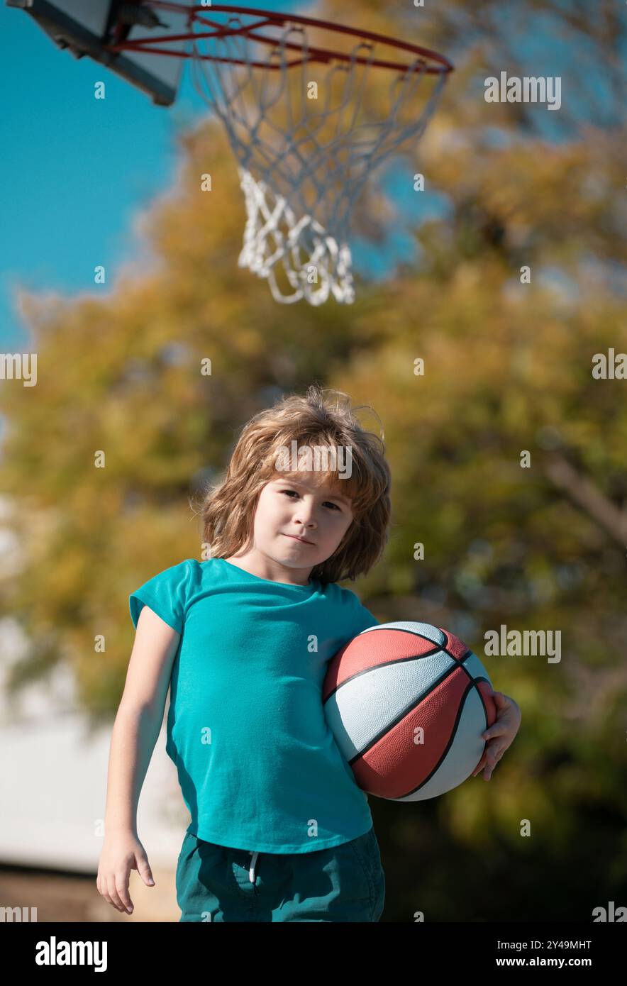 Happy little boy kid playing basketball on playground Stock Photo - Alamy