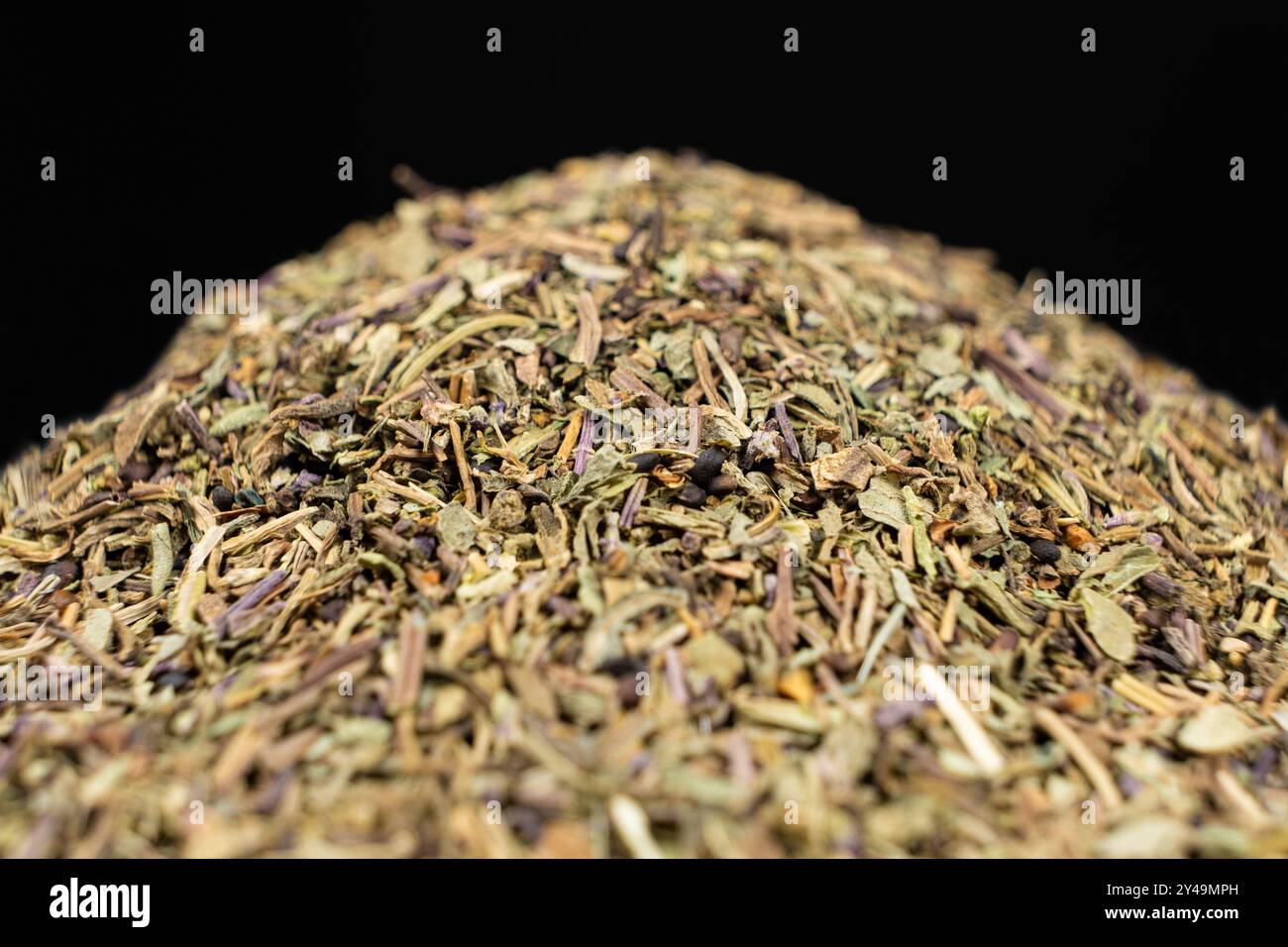Pile of chopped dry basil seasoning on a black background Stock Photo ...