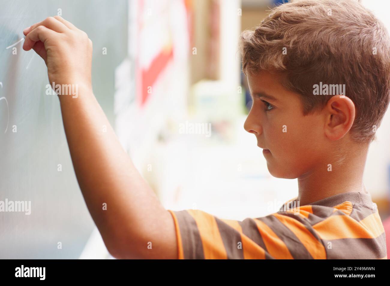 Writing, chalk and student by board in classroom for solving math ...