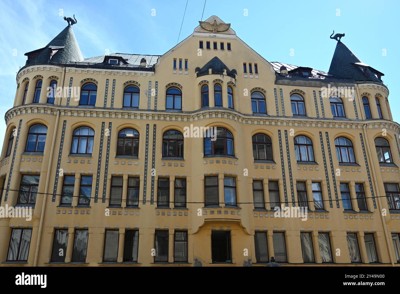 Cat House in Riga, Latvia. The cat sculpture on the roof of Cat House ...