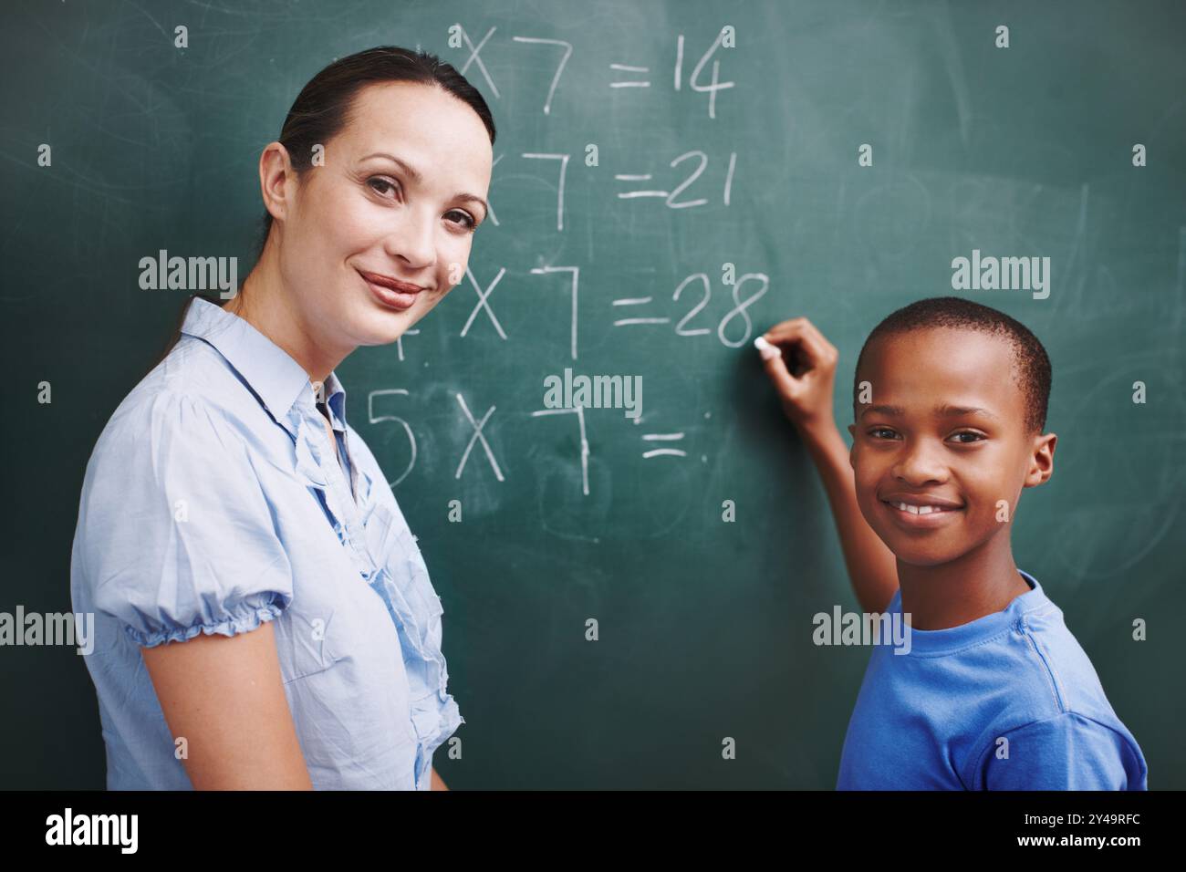 Math, teacher and student portrait at chalkboard in classroom for ...