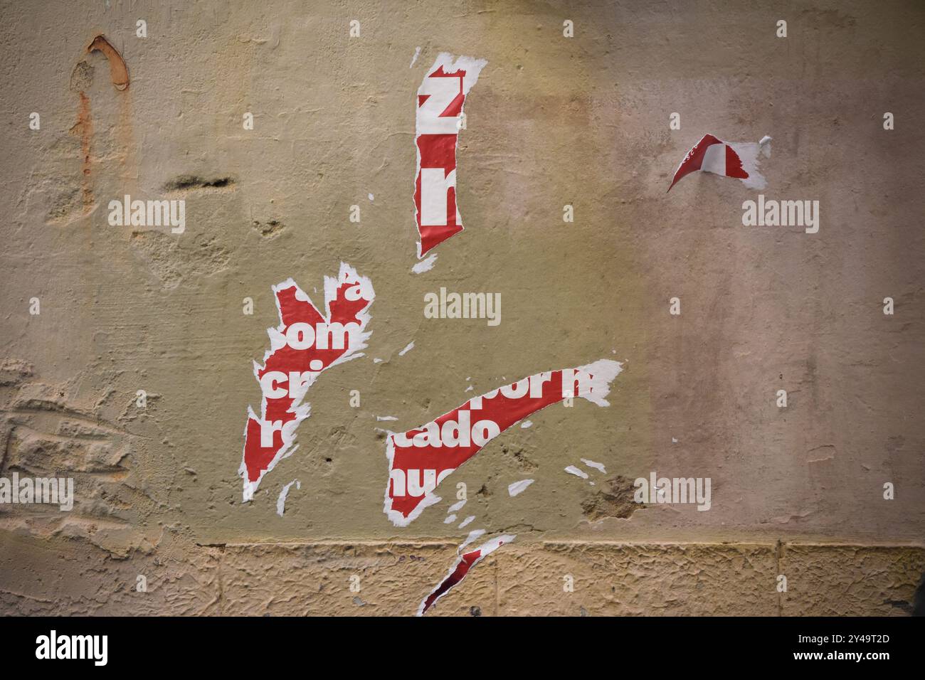 Torn paper with words stuck to the wall Stock Photo - Alamy
