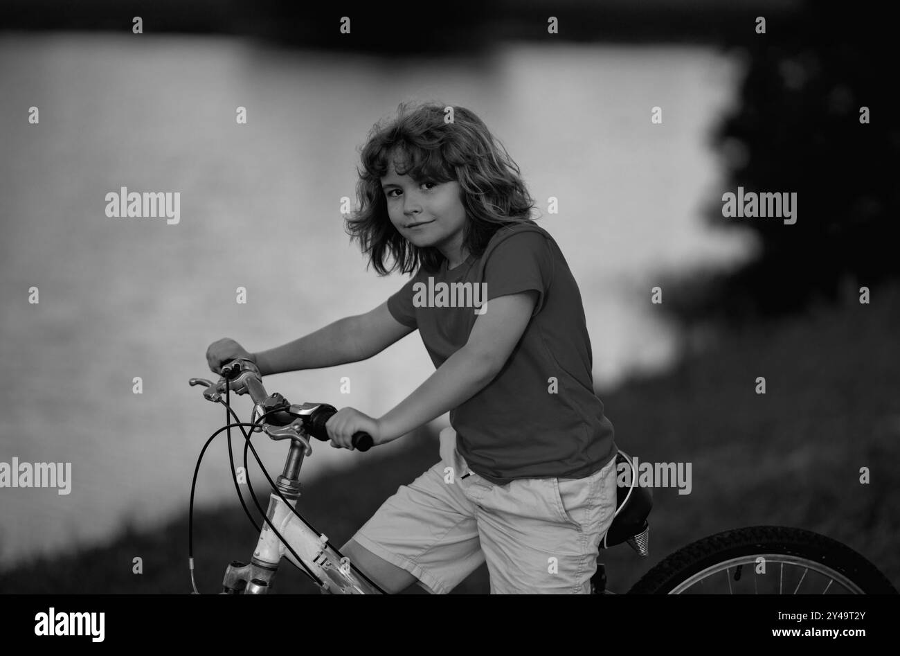Little kid boy ride a bicycle in the park. Kid cycling on bicycle ...