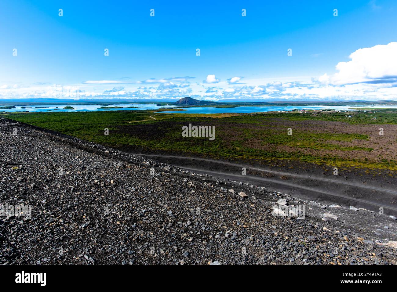 crater of Hverfjall volcano with black lava rocks in the background ...