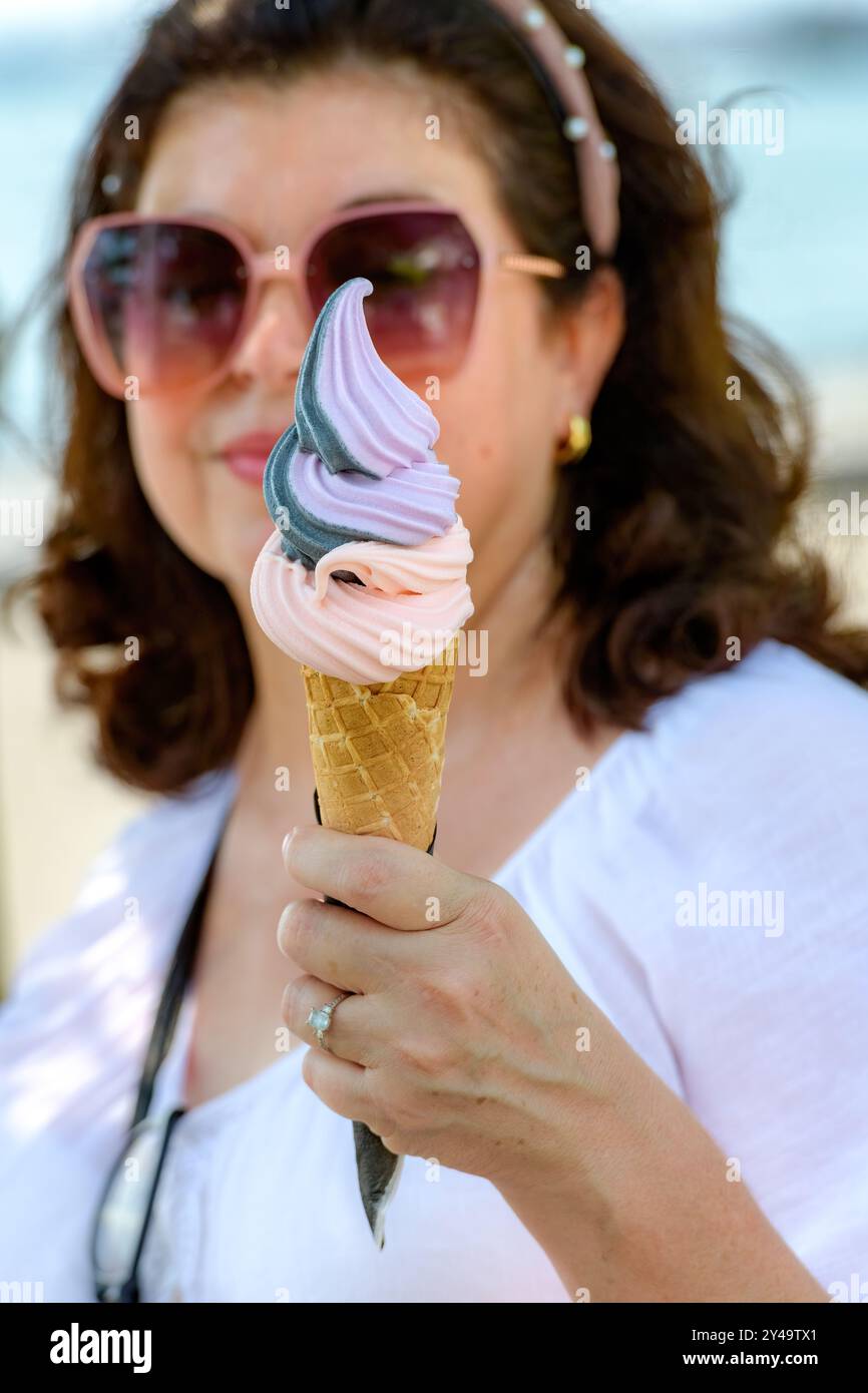 Latin American woman holding an ice cream cone during Summer season ...