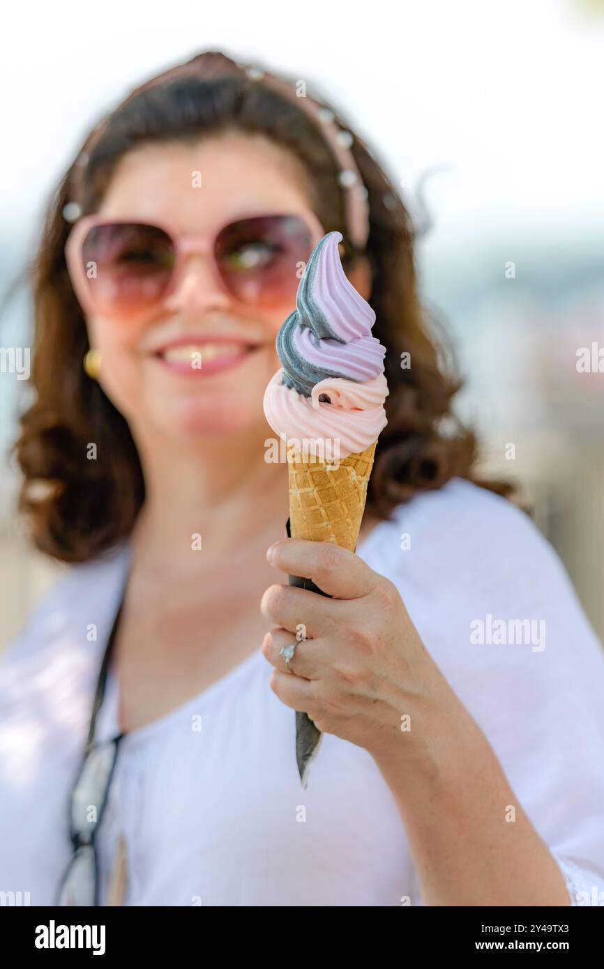 Latin American woman holding an ice cream cone during Summer season ...