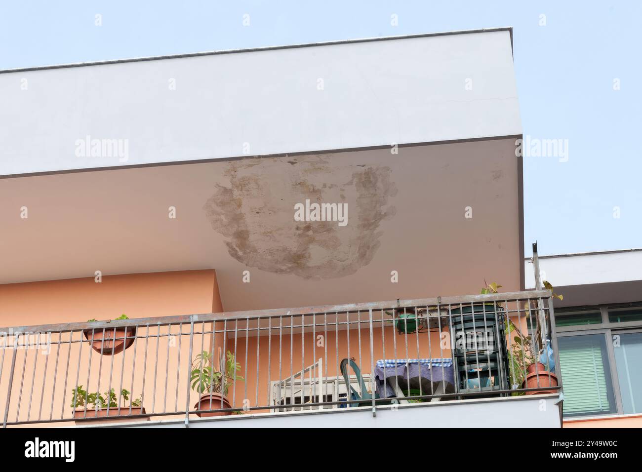 Water infiltration stain damaging the ceiling of a residential building ...