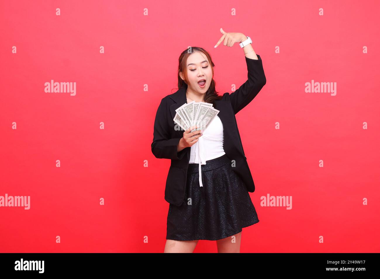gesture of young indonesia office female looking at money happy wearing ...