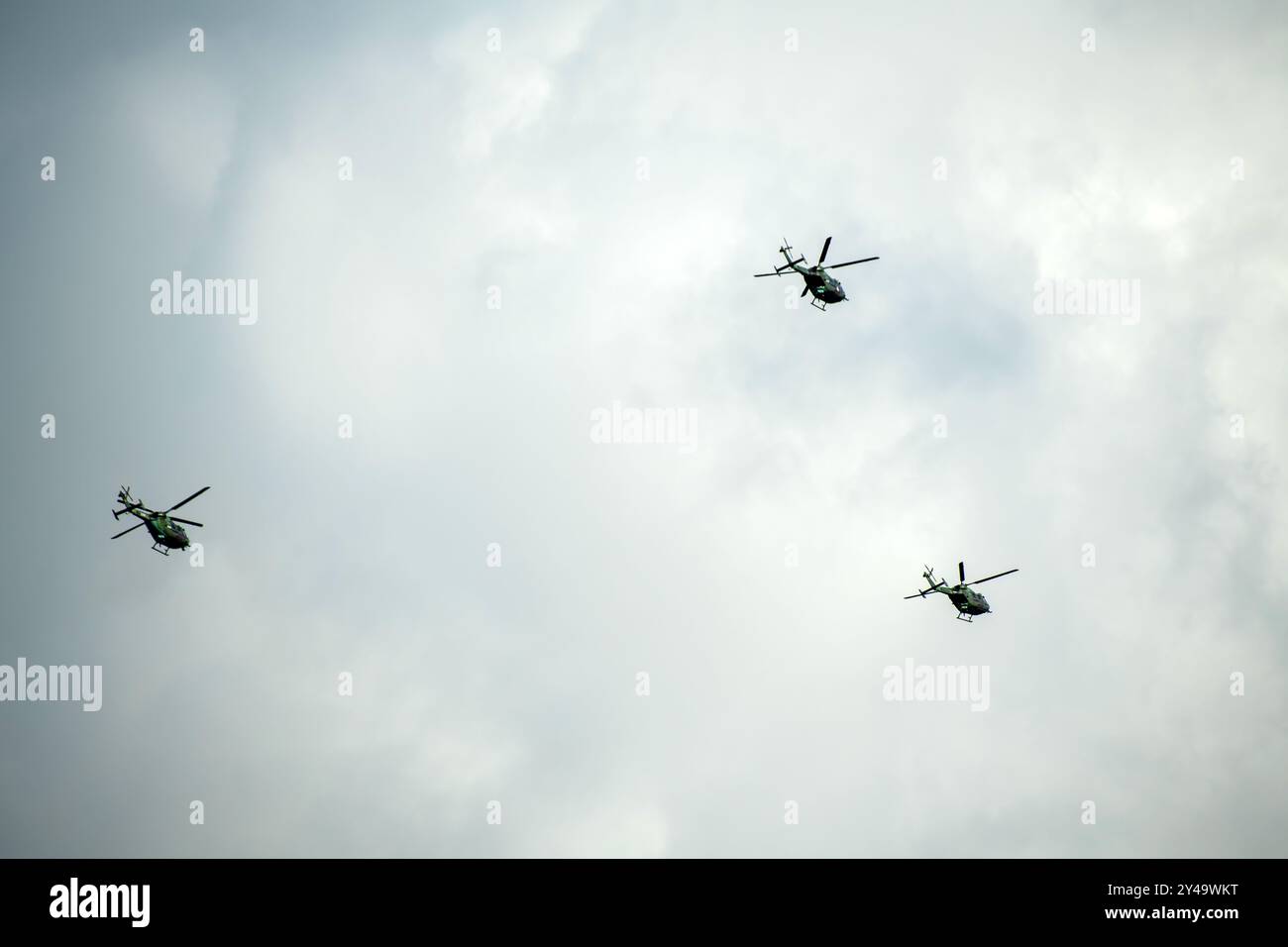 Helicopter formation against isolated cloudy mid-air sky Stock Photo ...