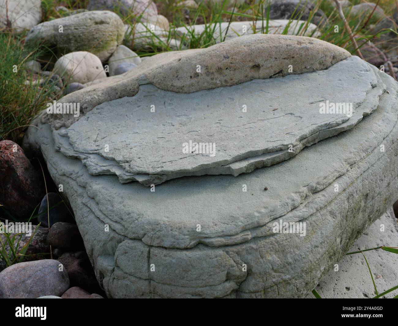 The natural stone features a light, porous surface with compact and ...
