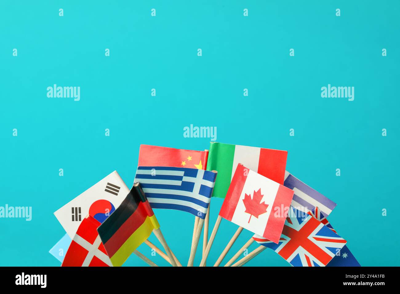 Small paper flags of different countries on light blue background Stock ...