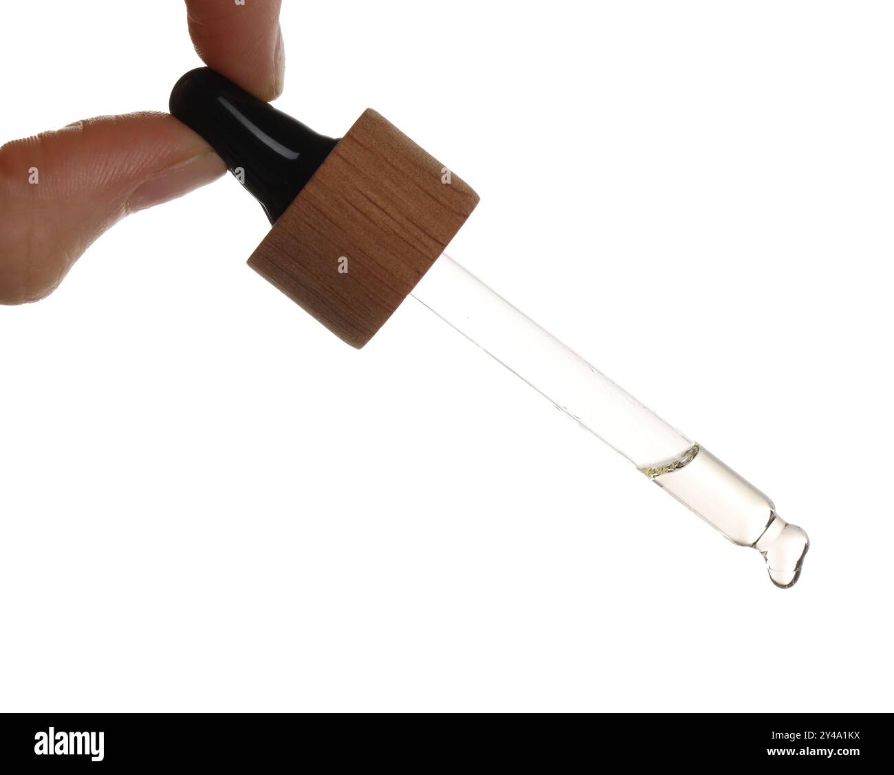 Essential oil dripping from pipette against white background Stock ...