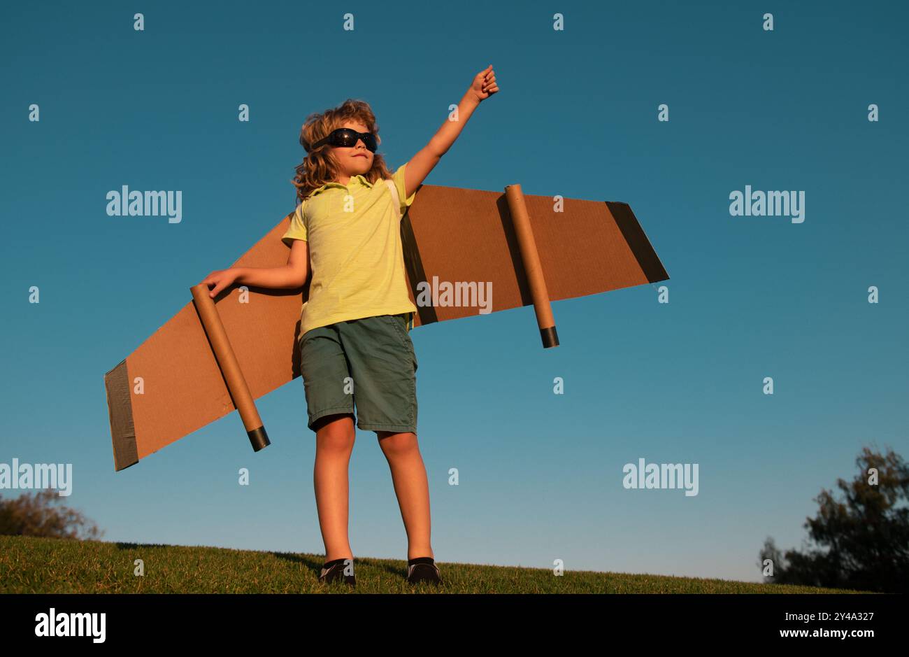 Kid superhero with jetpack. Boy pilot against a blue sky. Child pilot ...