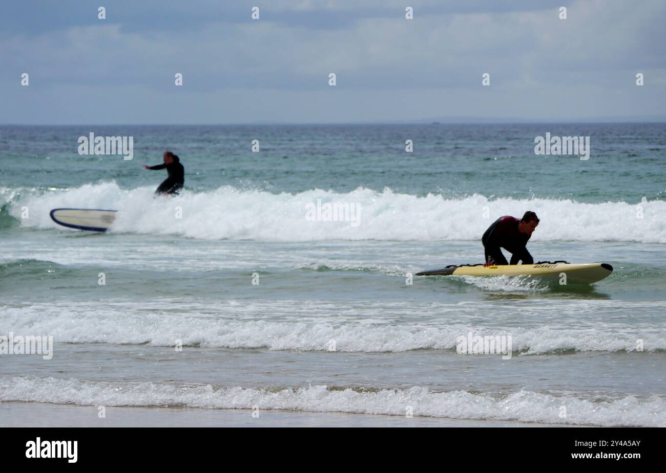 Two People Surfing in the Waves in Constantine Bay on the Southwest ...