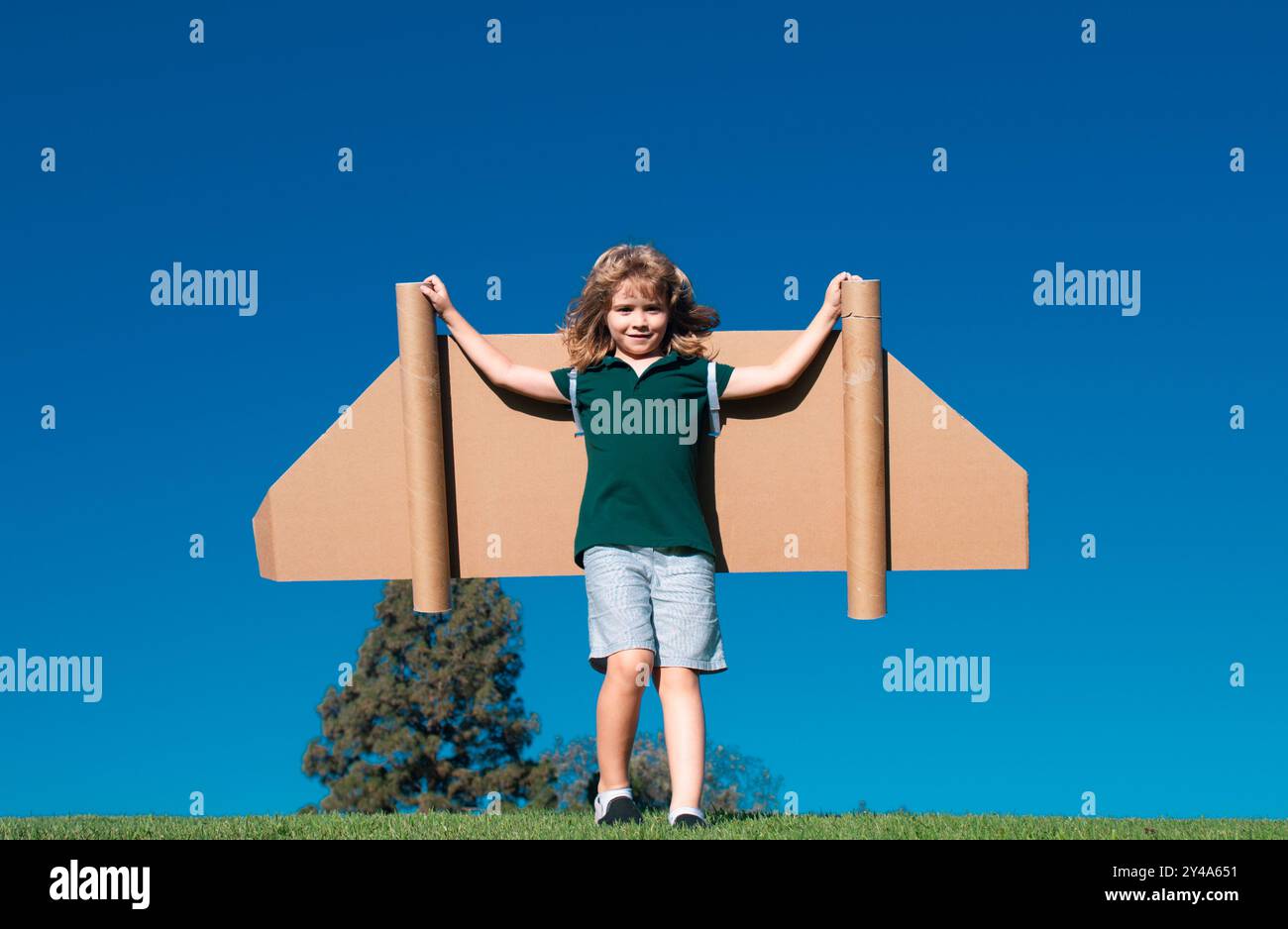 Dreams of travel. Child flying on jetpack with toy airplane on sky ...