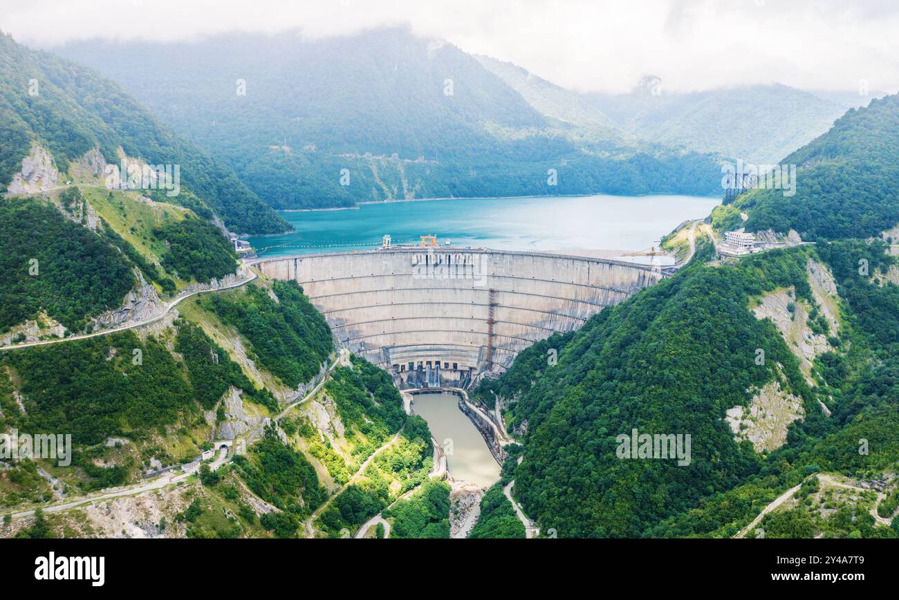 Aerial view of Enguri dam in Georgia surrounded by lush green mountains ...