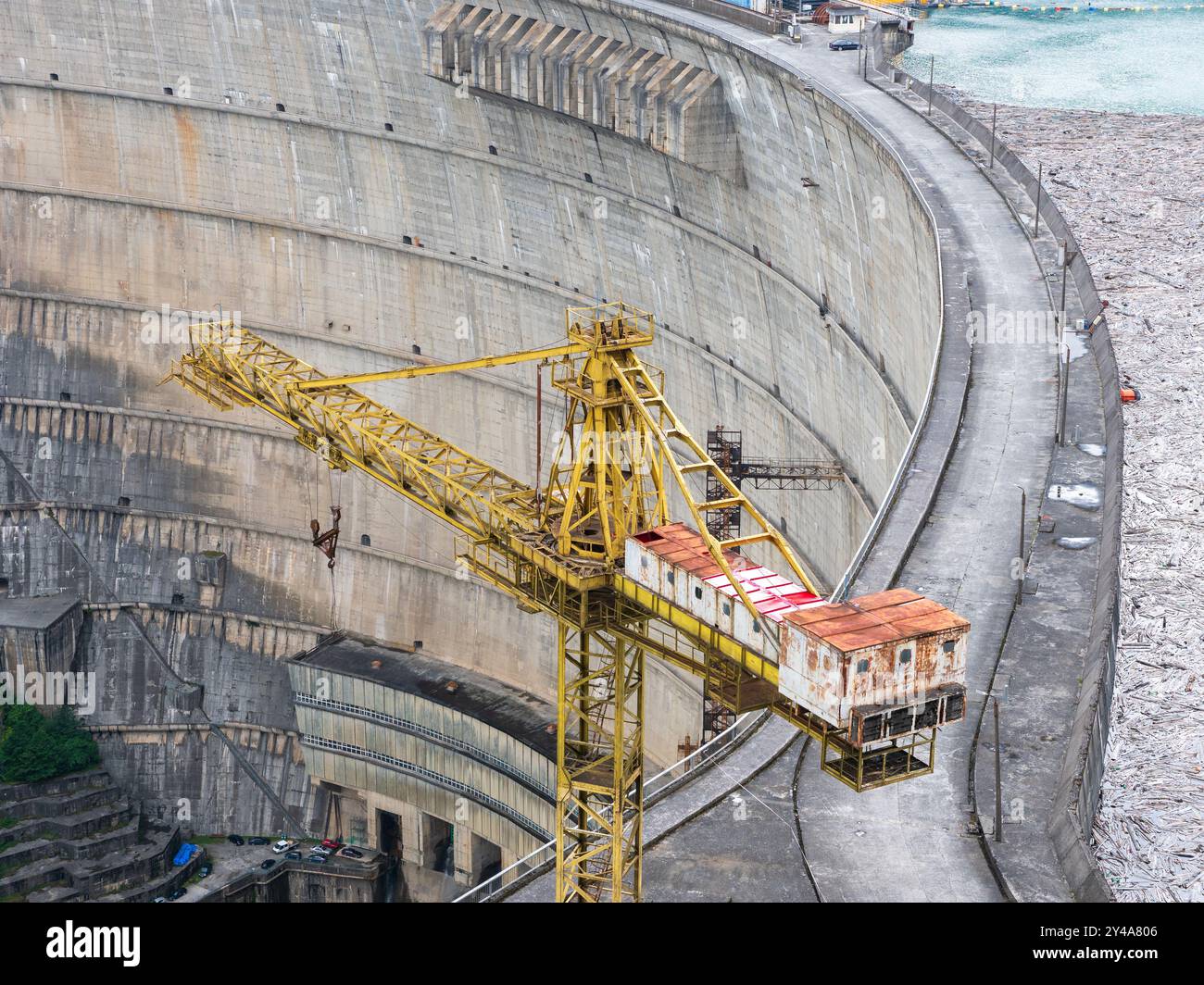 Yellow crane on Enguri dam in Georgia. Industrial equipment stands ...