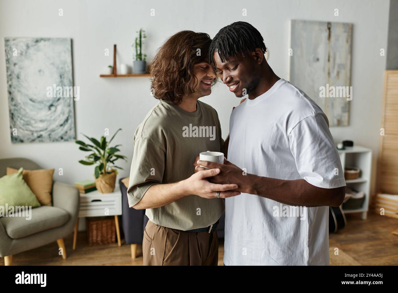 Two partners share a warm and intimate moment together, smiling and ...