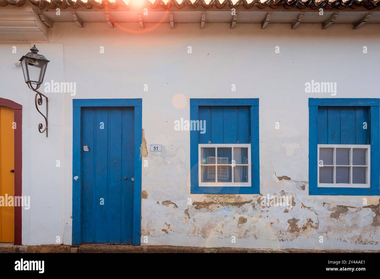 Paraty, Brazil. Old house facade from the colonial period. Wooden doors and windows with blue ...