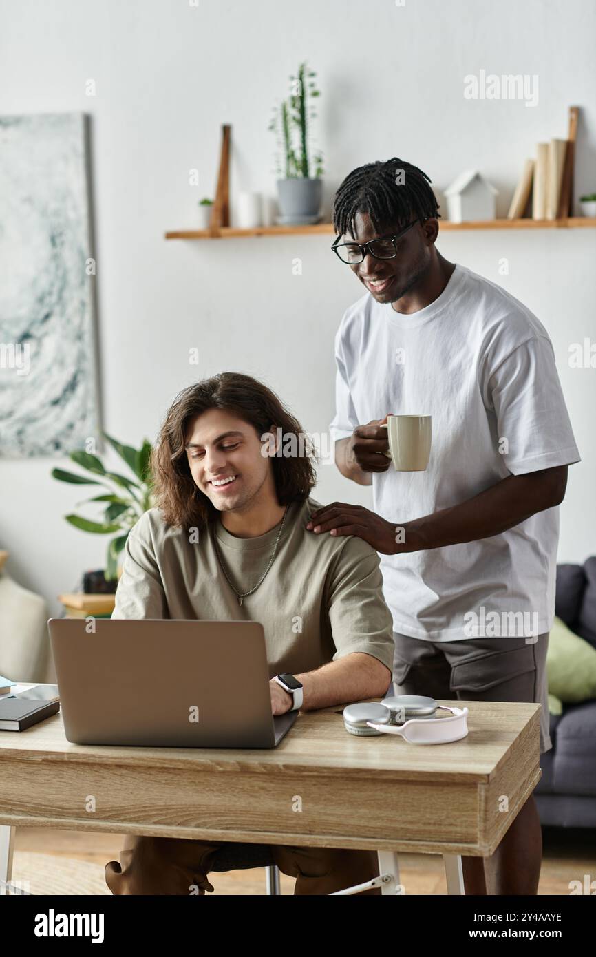 A joyful couple shares moments at home while one partner works on the ...