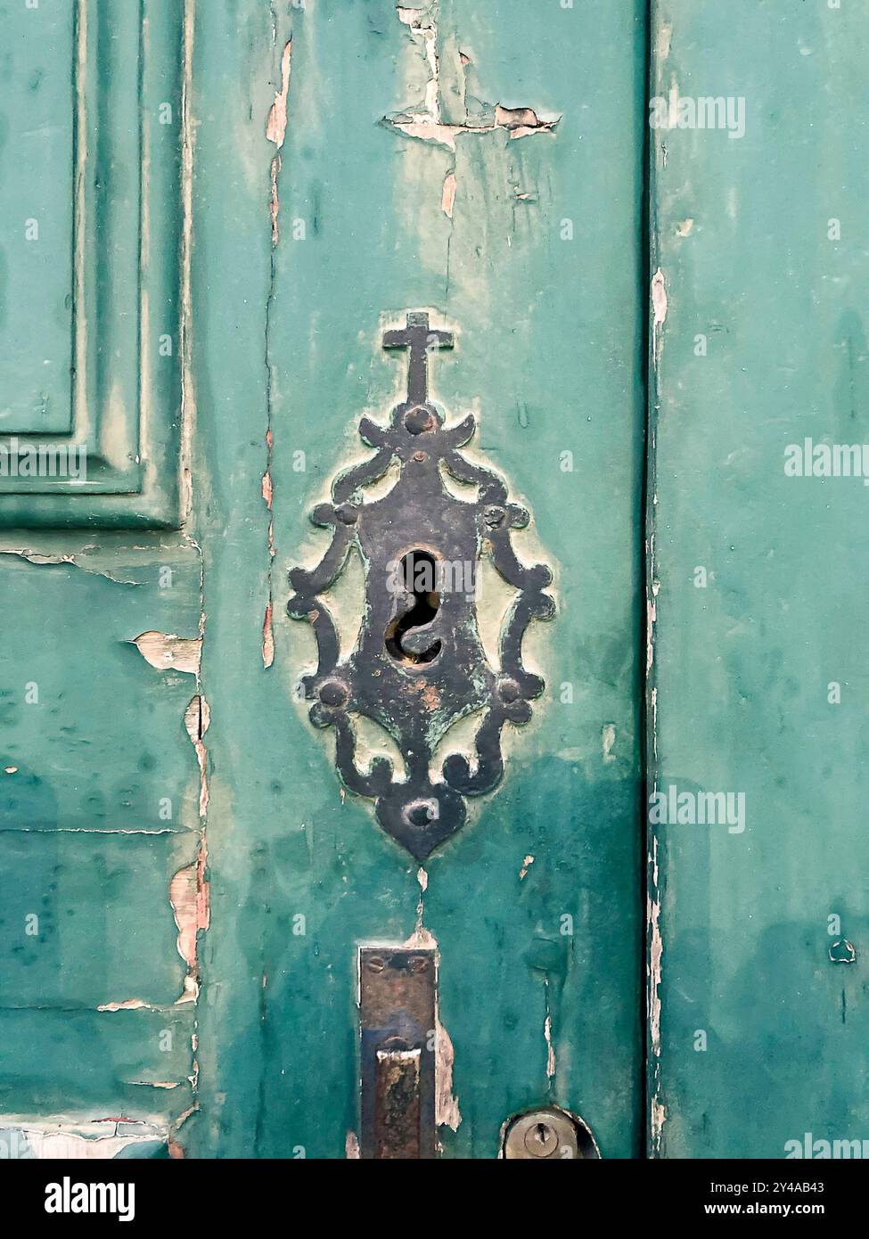 Old lock from the colonial period. Wooden door with peeling paint ...