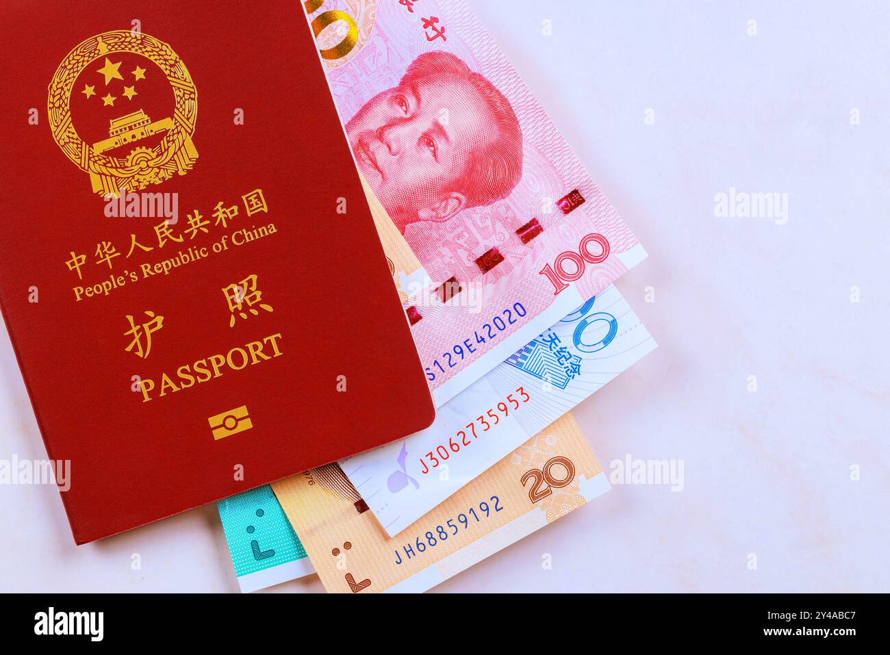 Chinese passport with Chinese cash currency in form of yuan cash ...