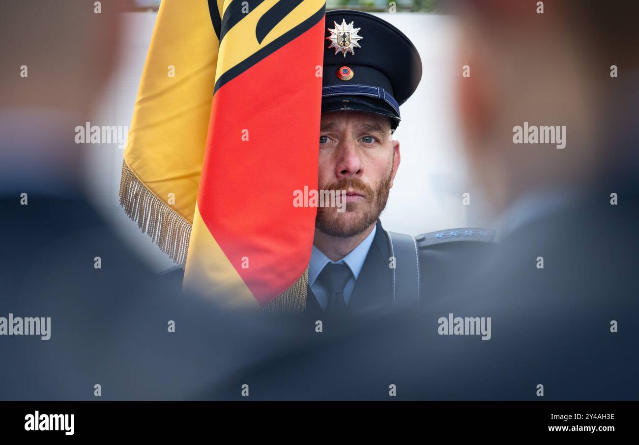 PRODUCTION - 17 September 2024, Hesse, Frankfurt/Main: A flag bearer ...