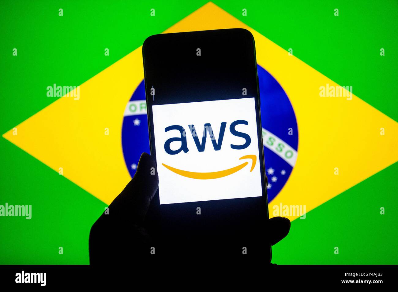 In this photo illustration, an AWS logo seen displayed on a smartphone with a Brazilian flag in ...