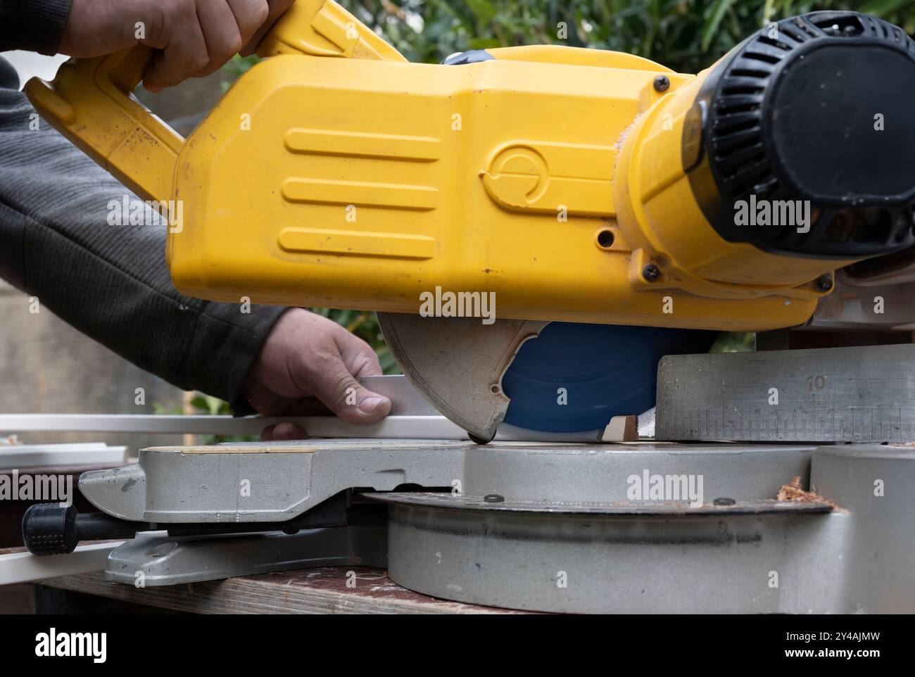 Carpenter cuts a slat at an angle with a circular cross-cut saw, ideal ...