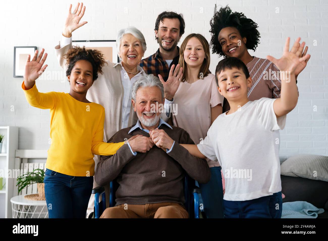 Multi generation, multiethnic family at home together, grandfather with ...