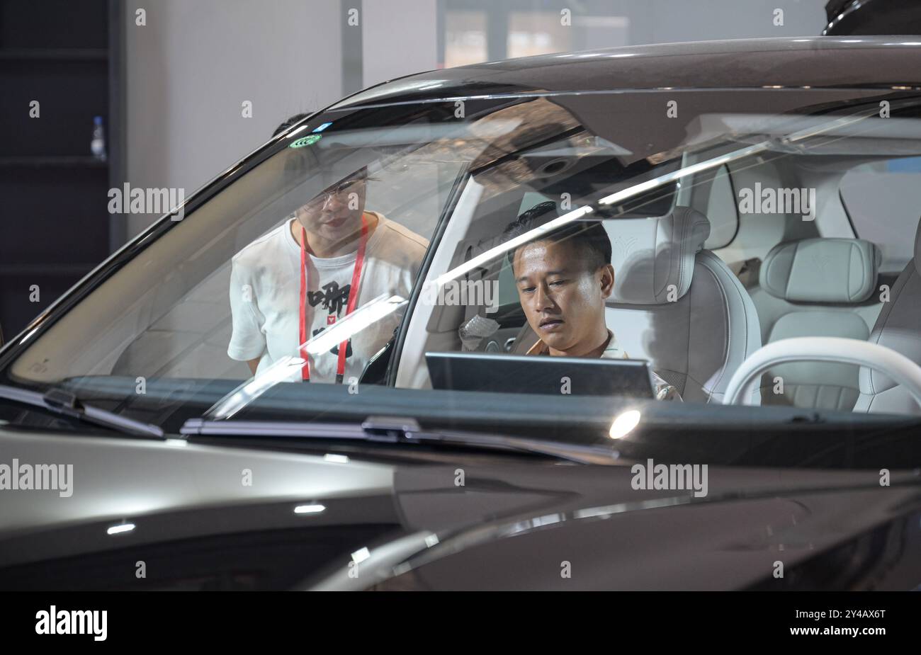 Haikou, China's Hainan Province. 16th Sep, 2024. A visitor sits in a ...