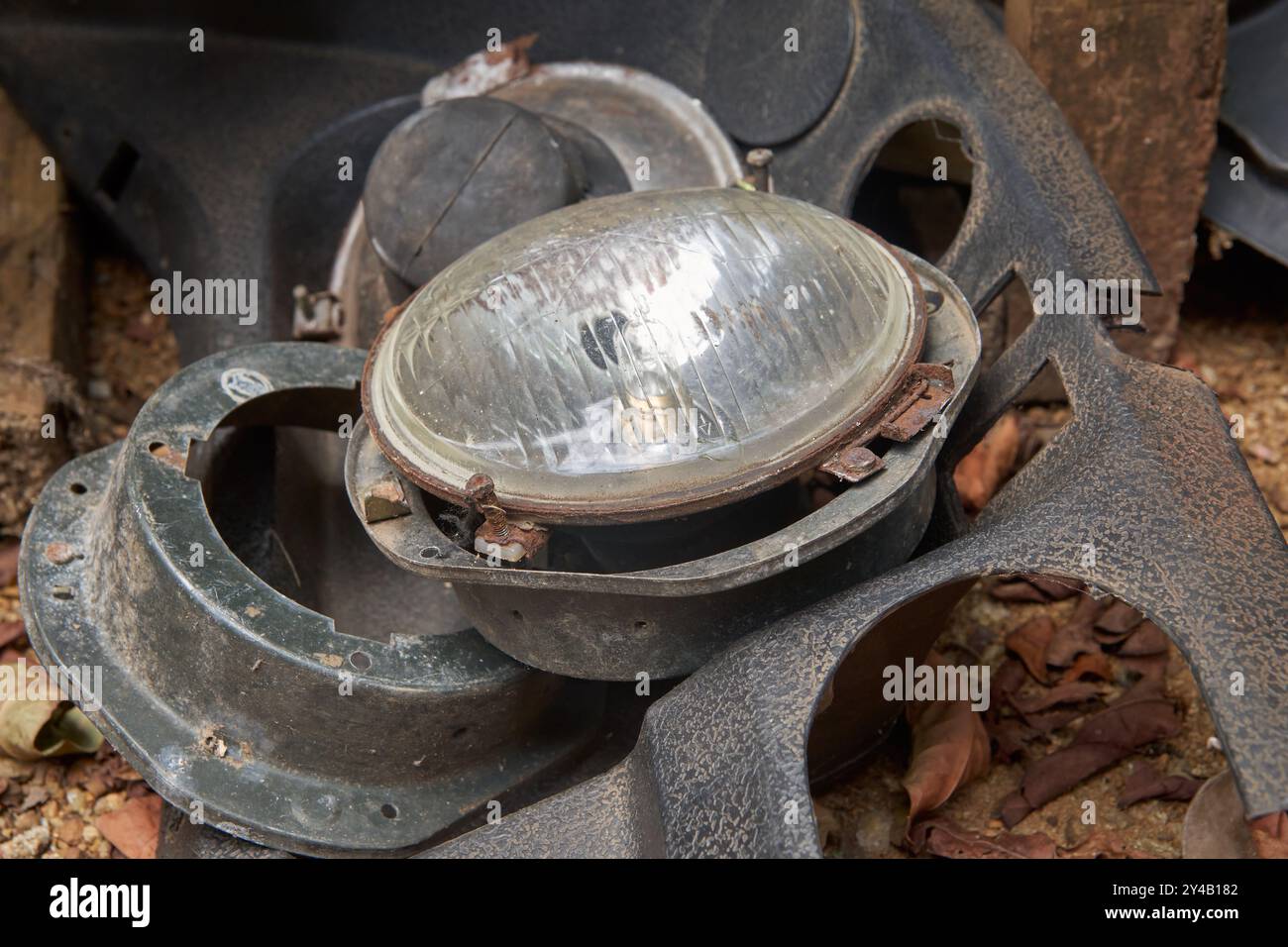 old discarded car headlights and other spare parts in scrapyard close ...