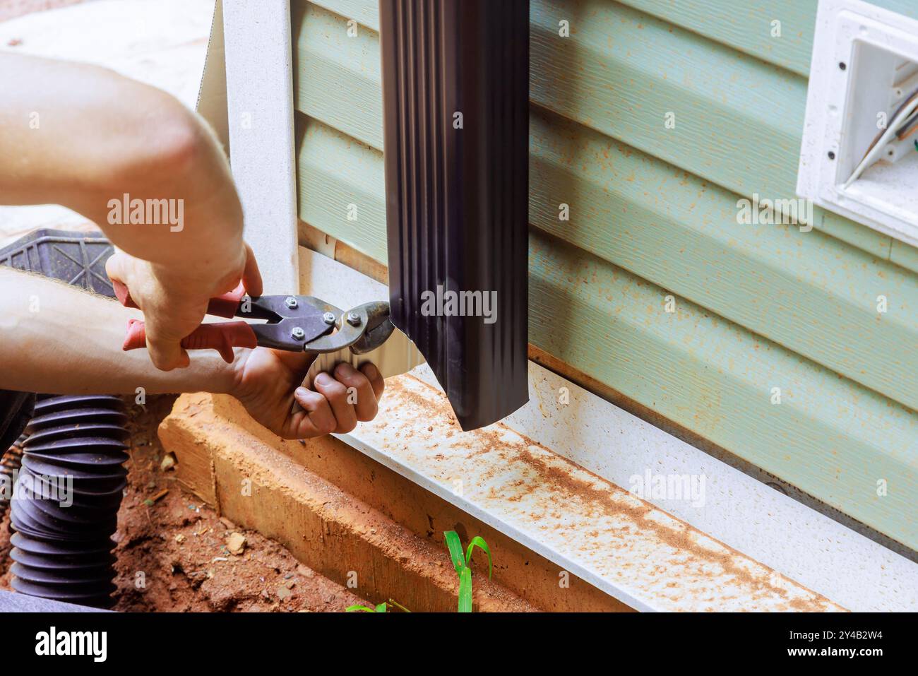 Handyman it is assembling with installation of gutter channel are ...