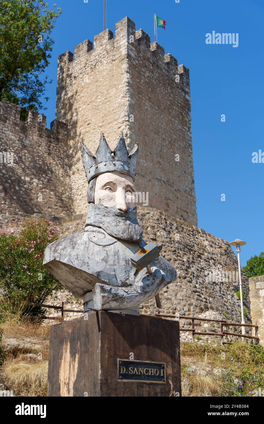 Contemporary style stone bust of portuguese King D. Sancho I in front of the Castelo de Torres ...