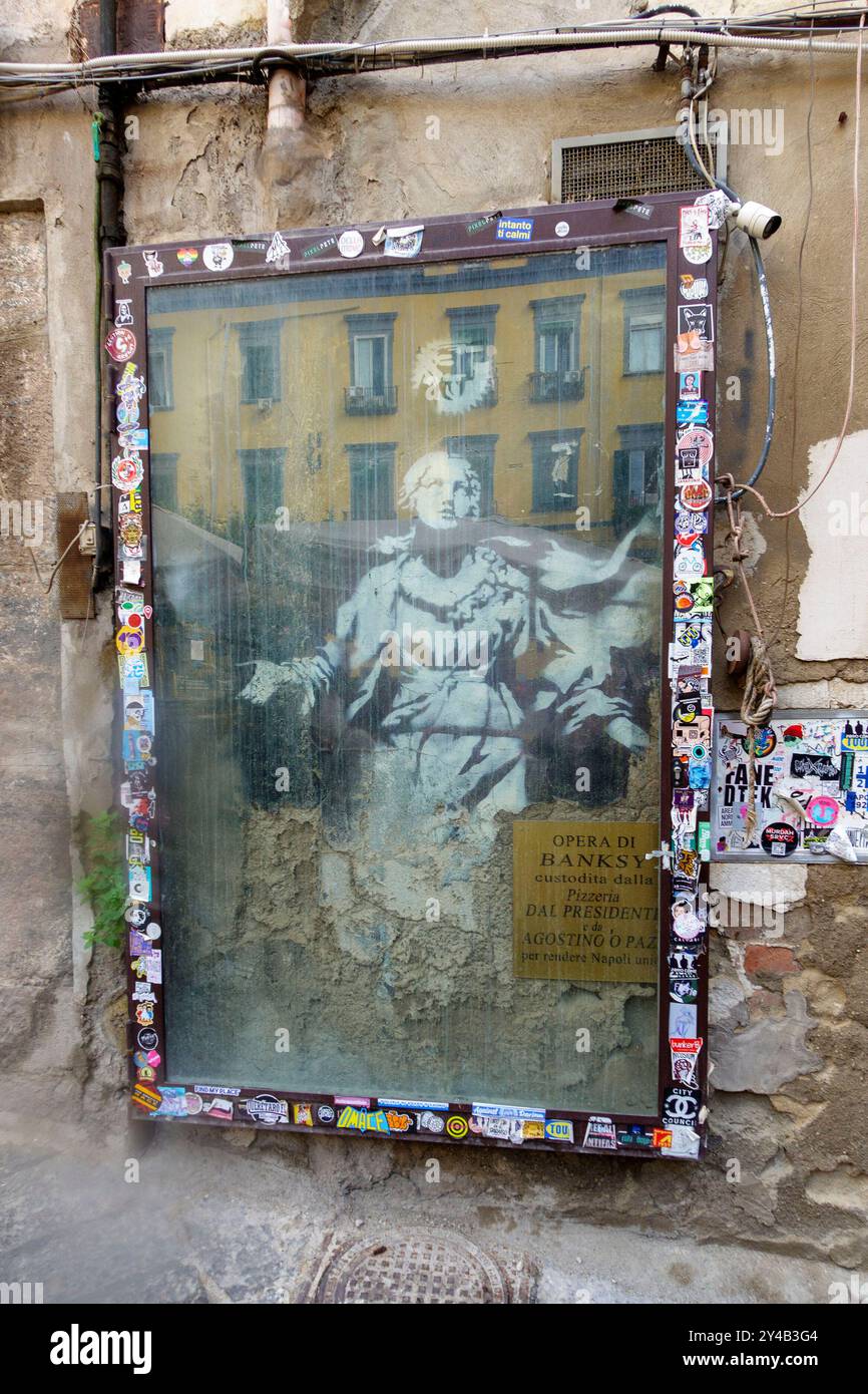 Banksy artwork on a wall in Naples, Italy, featuring an image of the ...