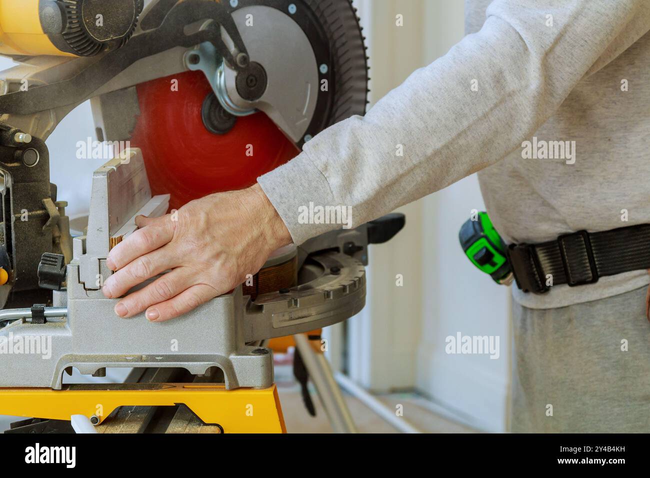 Using an electric circular saw at sawmill, professional carpenter cuts ...