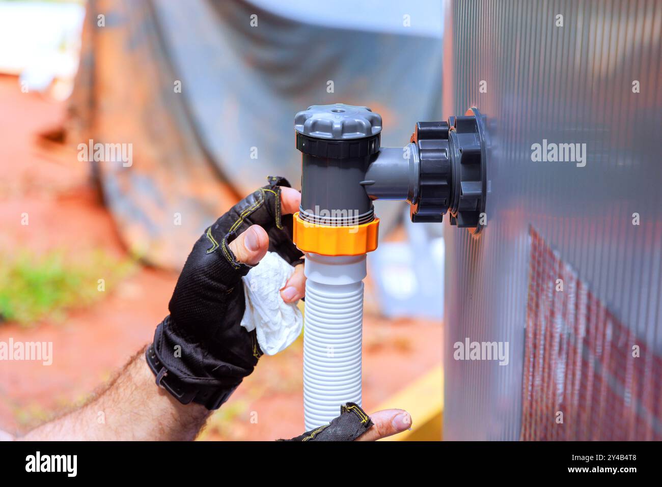 An employee of an environmental maintenance company installs water ...