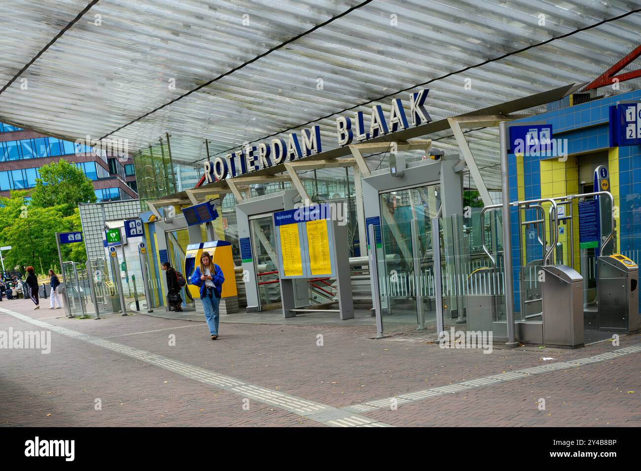 People walking by the main entrance to Rotterdam Blaak railway station ...