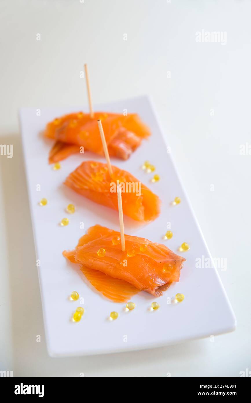 Smoked salmon with pearls of olive oil Stock Photo - Alamy