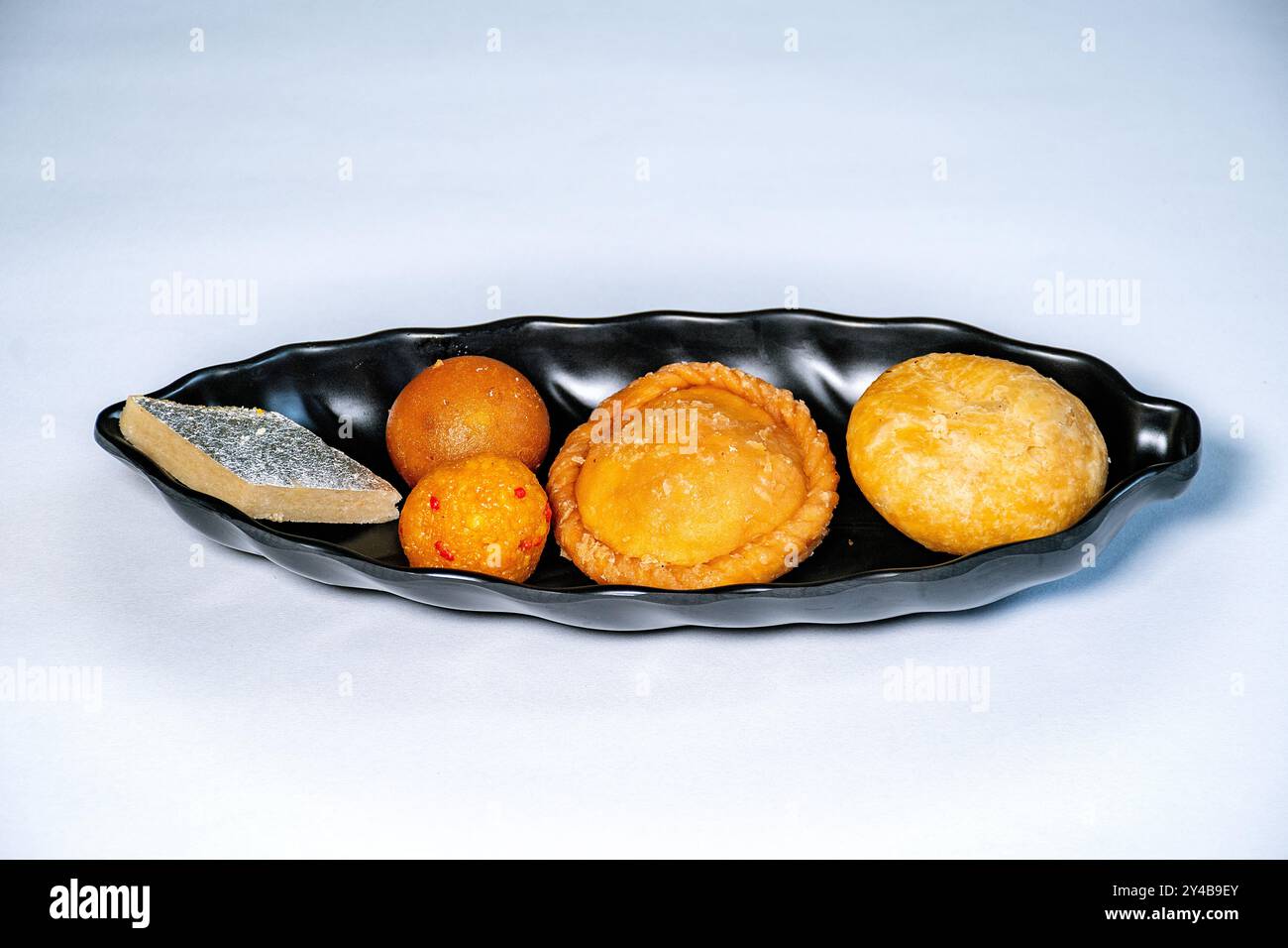 Well-decorated Indian traditional sweets and snacks such as Kachuri ...