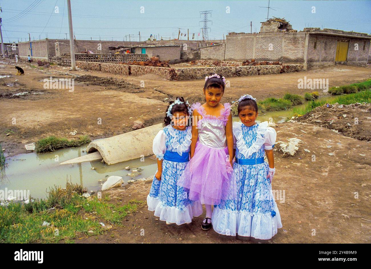 Mexico, Mexico City. Girls in slum area with broken sewage after their ...
