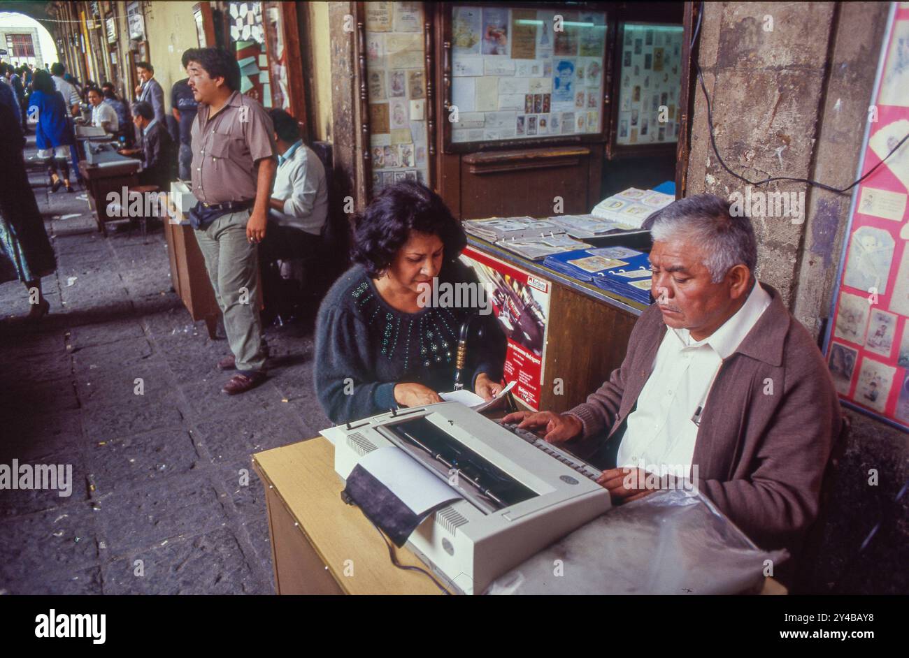 Mexico, Mexico-City - Writers fill out official forms on a typewriter ...