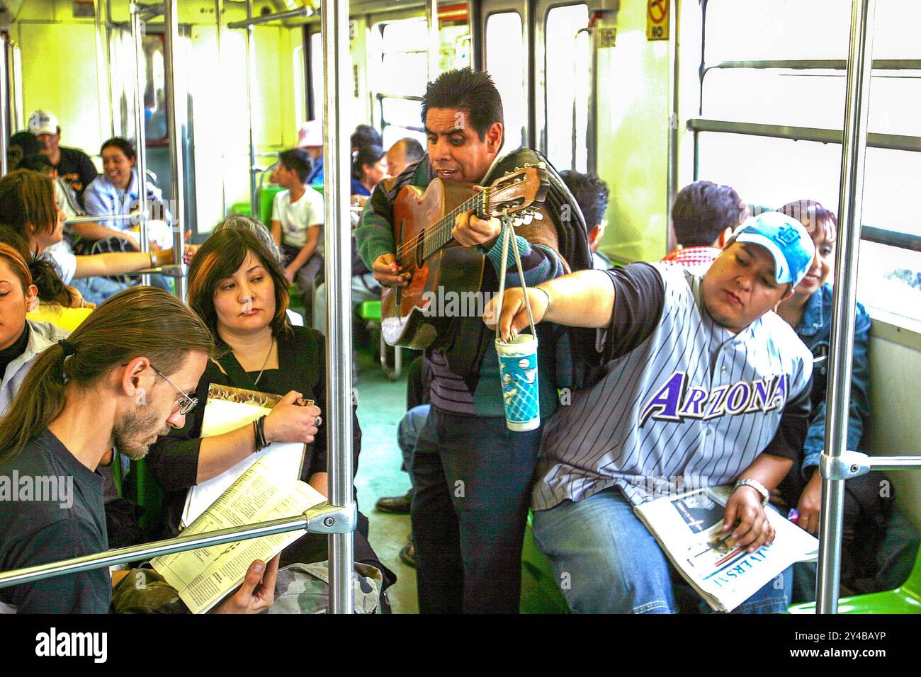 Mexico, Mexico-City, Street musician in the metro receiving money from ...