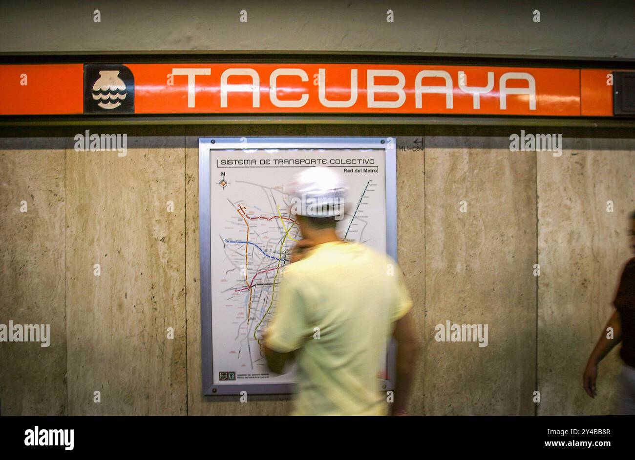 Mexico - a passenger looks at the metro lines map in the Tacubaya metro ...