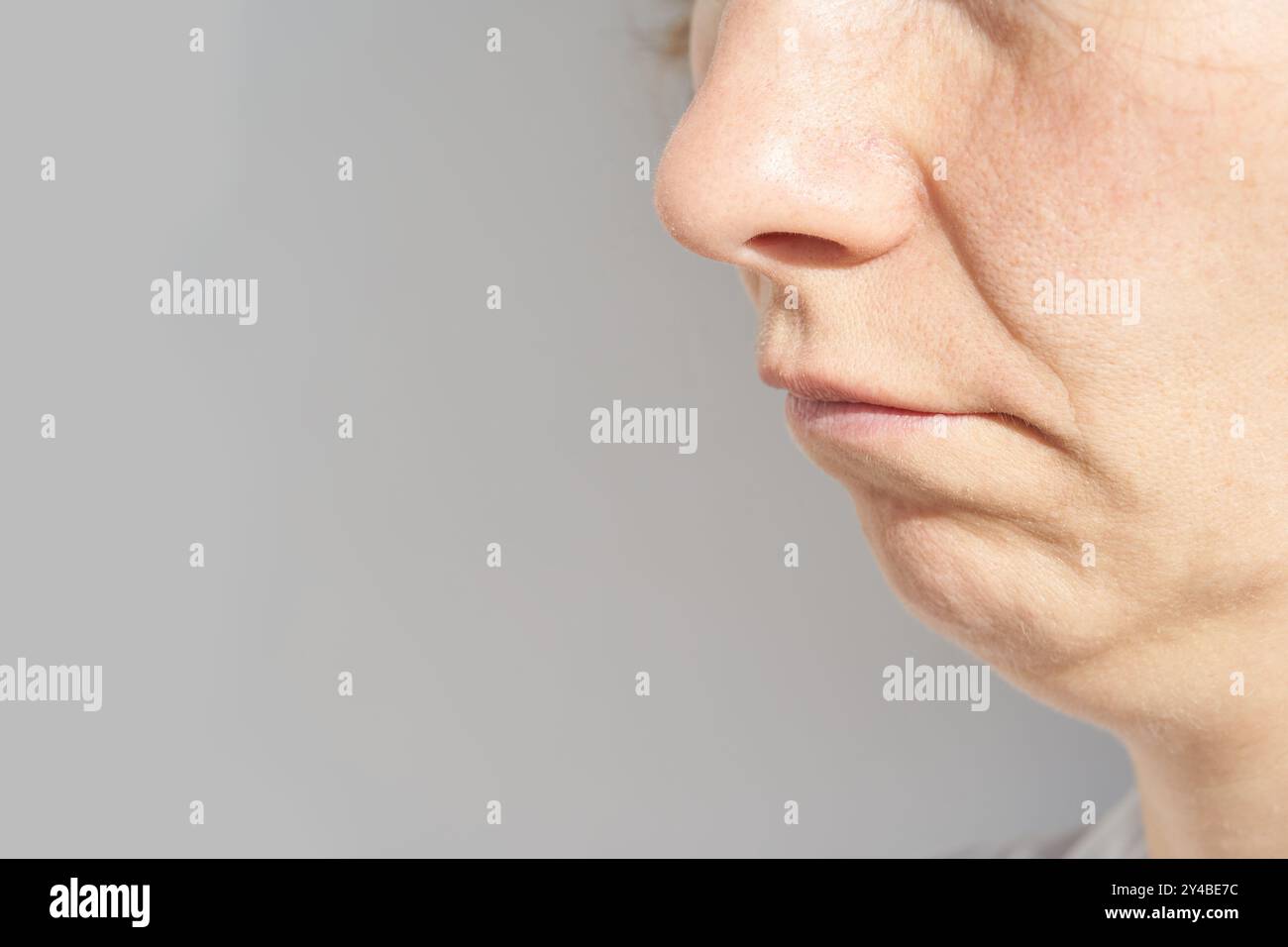 Close-up of mature woman's lower face showing natural skin texture and ...
