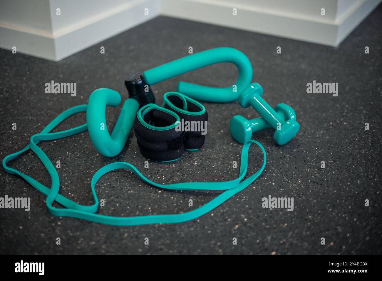 Different types of gym training equipment are spread out on the gym ...